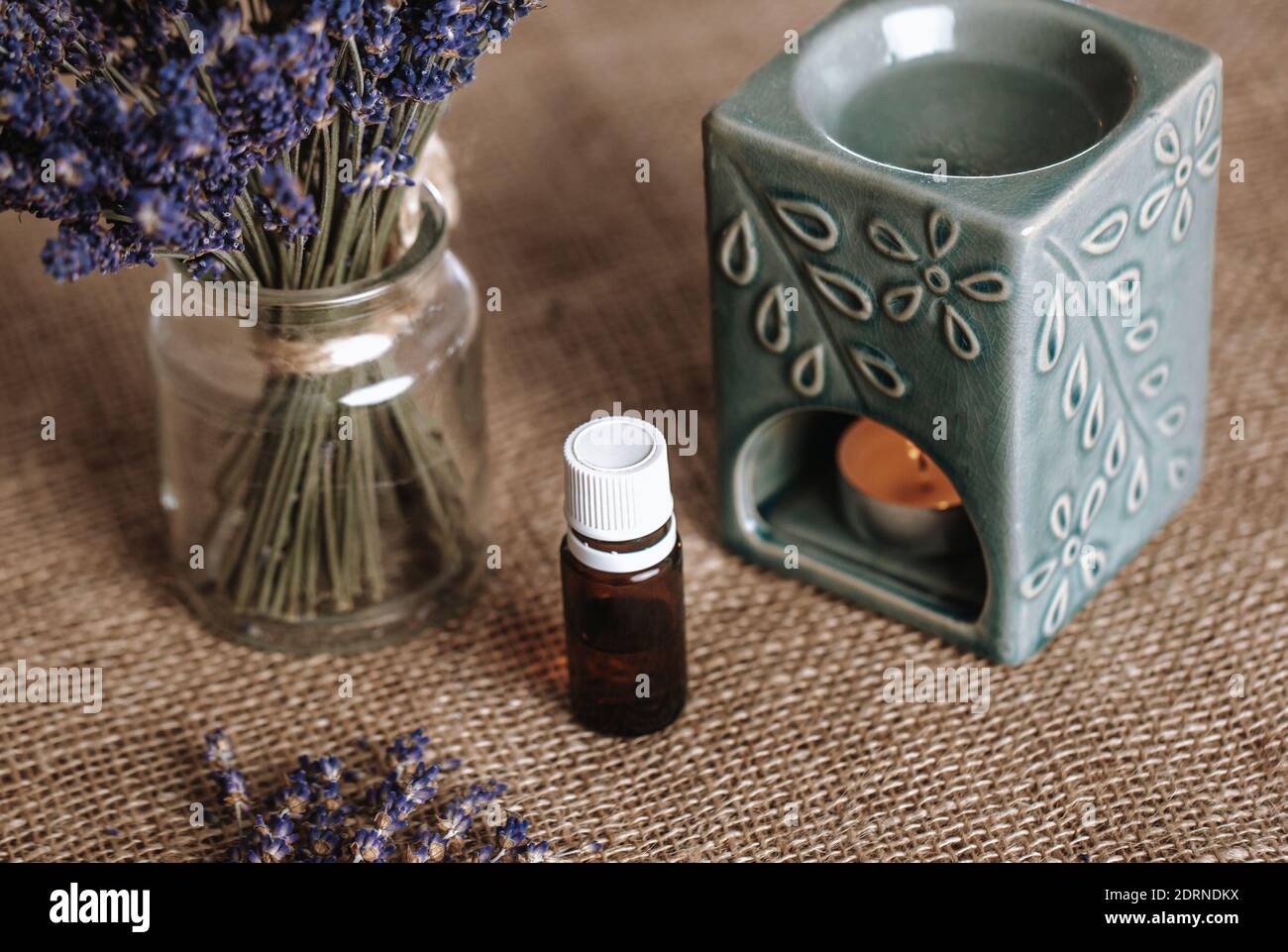 Aroma lamp with a burning candle and essential oil, background with ...