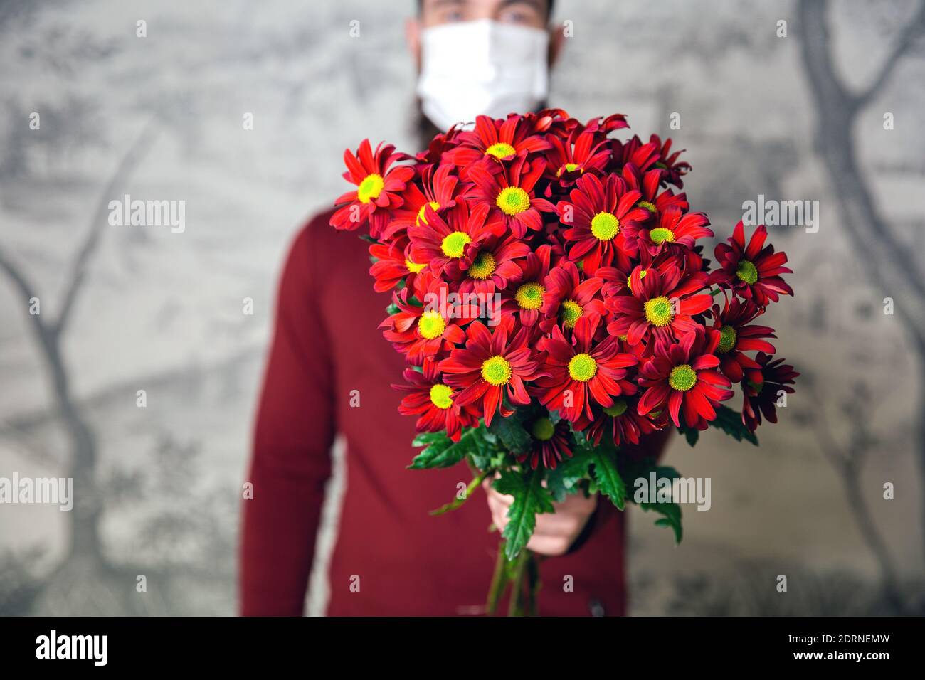 Young male with protective face mask for Coronavirus with flower ...