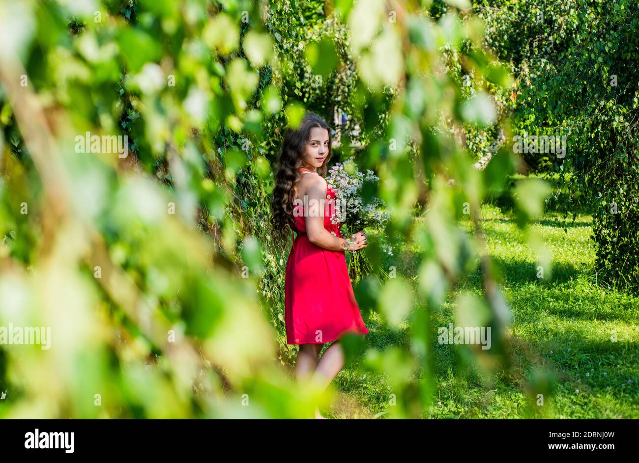 Fancy teen girl in red dress enjoying pure nature on summer day Stock ...