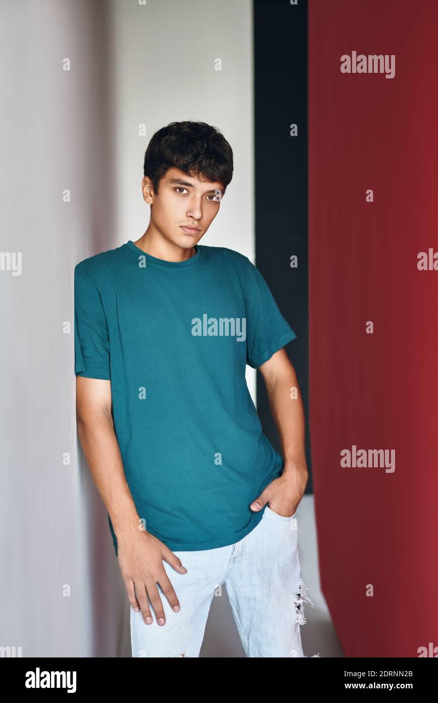 Young handsome mixed race man posing on studio background looking to ...