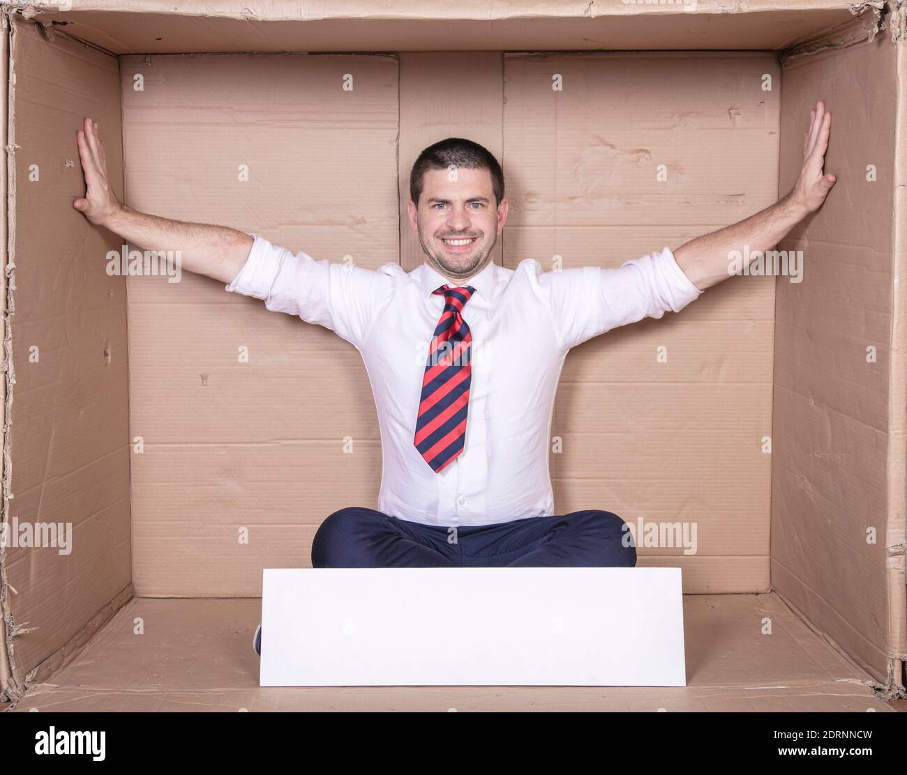 businessman expands his cardboard box, more space to work Stock Photo ...