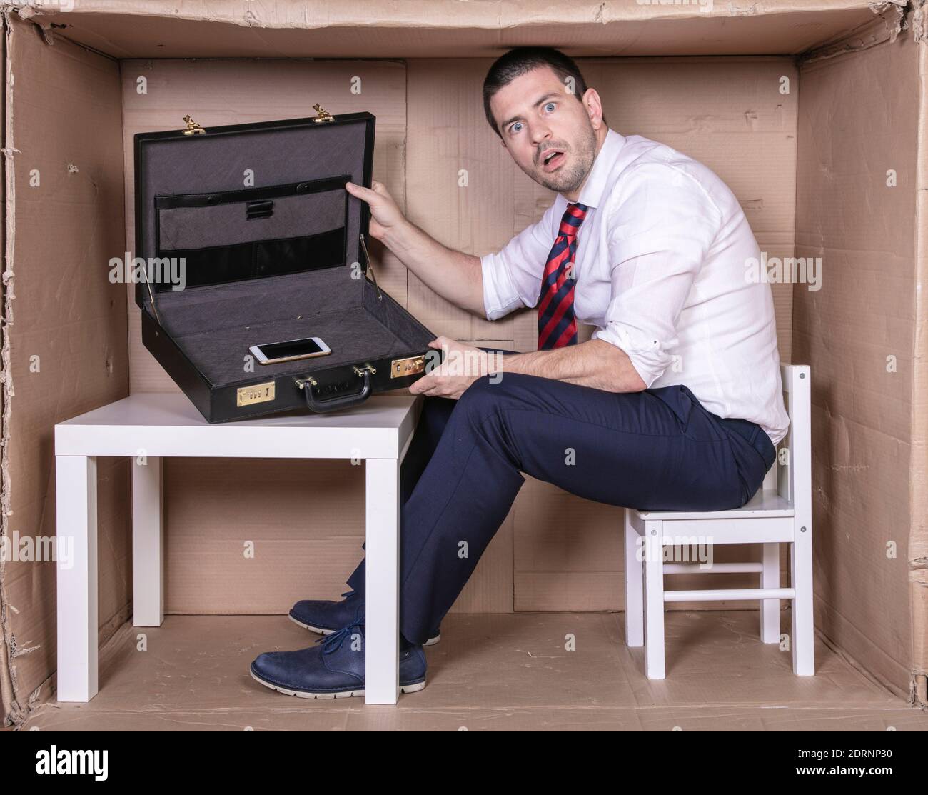 furious businessman shows empty briefcase Stock Photo - Alamy