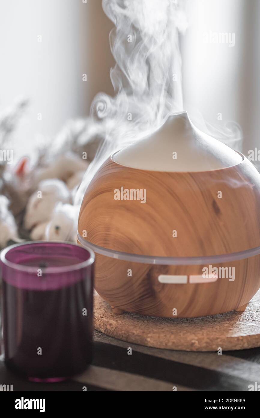 Aroma oil diffuser lamp on a table. Aromatherapy and health care ...
