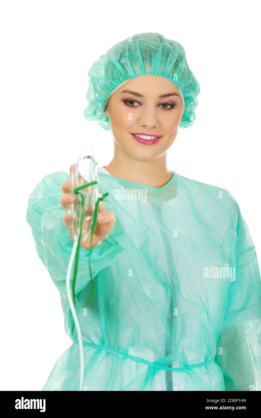 Female Doctor Holding Oxygen Mask While Standing Against White ...