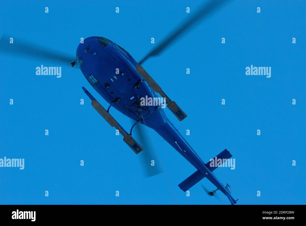 Rescue helicopter in the middle of flight viewed from below Stock Photo ...