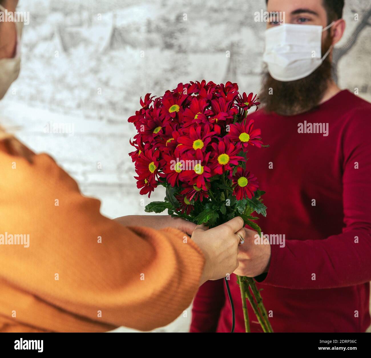 Young romantic loving male wearing a protective face mask for ...