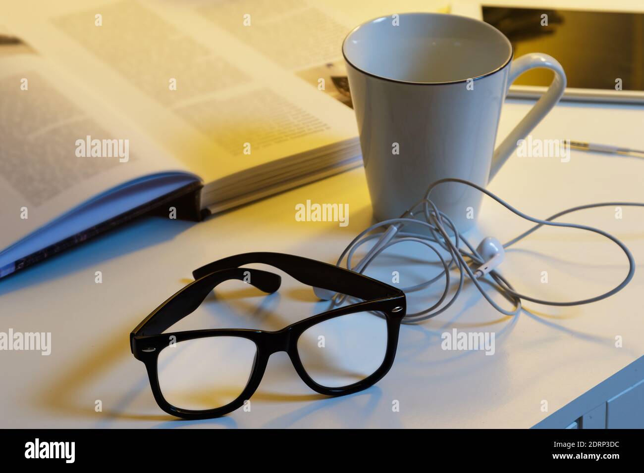 Different objects on the desk - Cup of hot drink, spectacles, books and ...