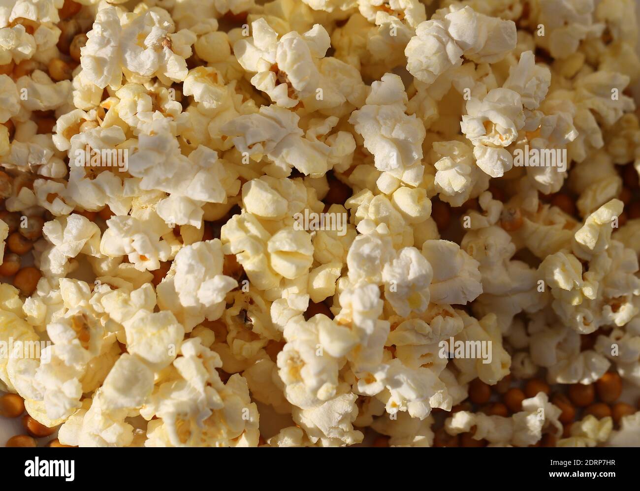 Photo background of salty popcorn illuminated by the sun. Example of ...