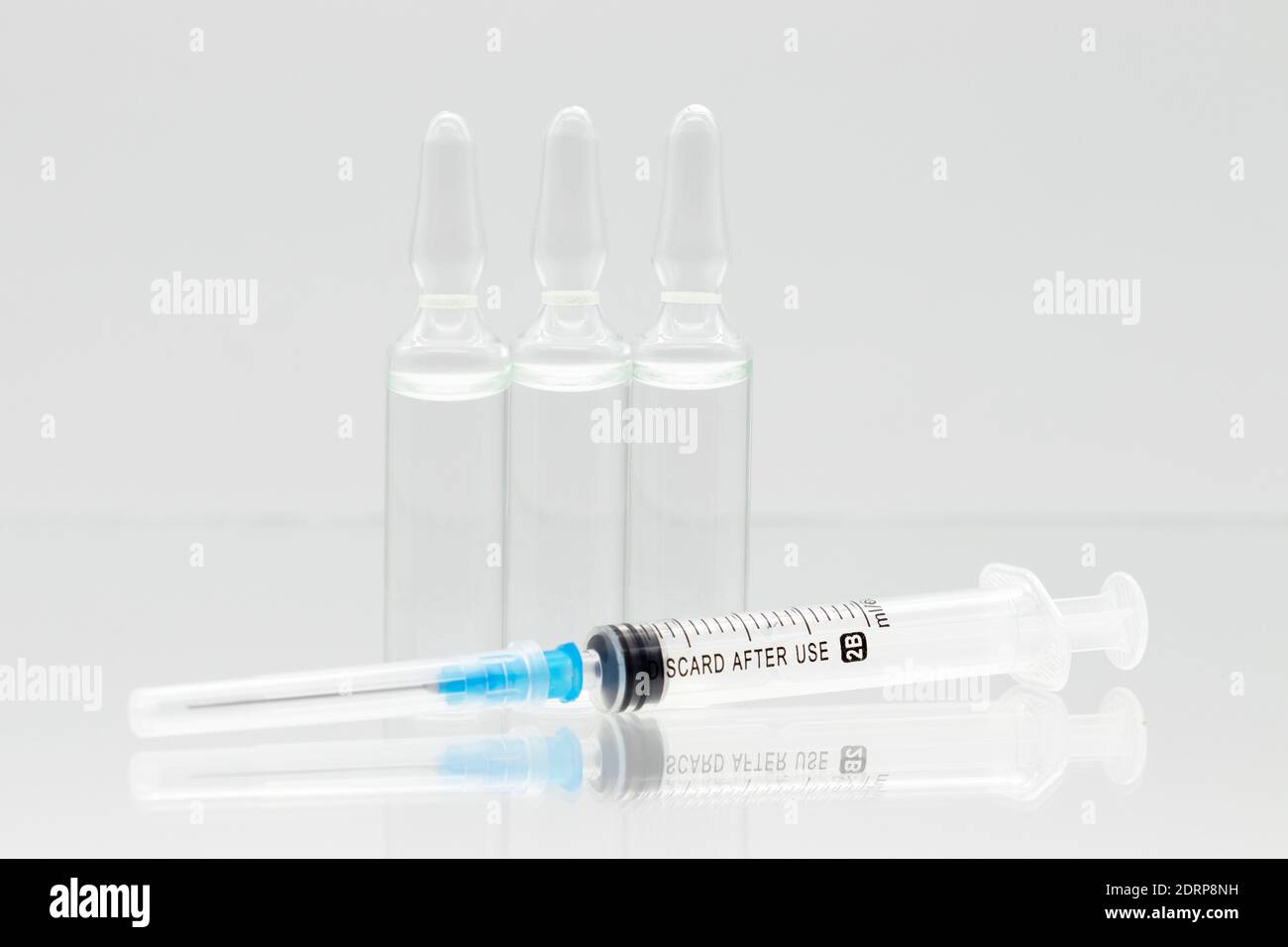 Glass medicine ampoules with liquid and plastic syringe with needle ...