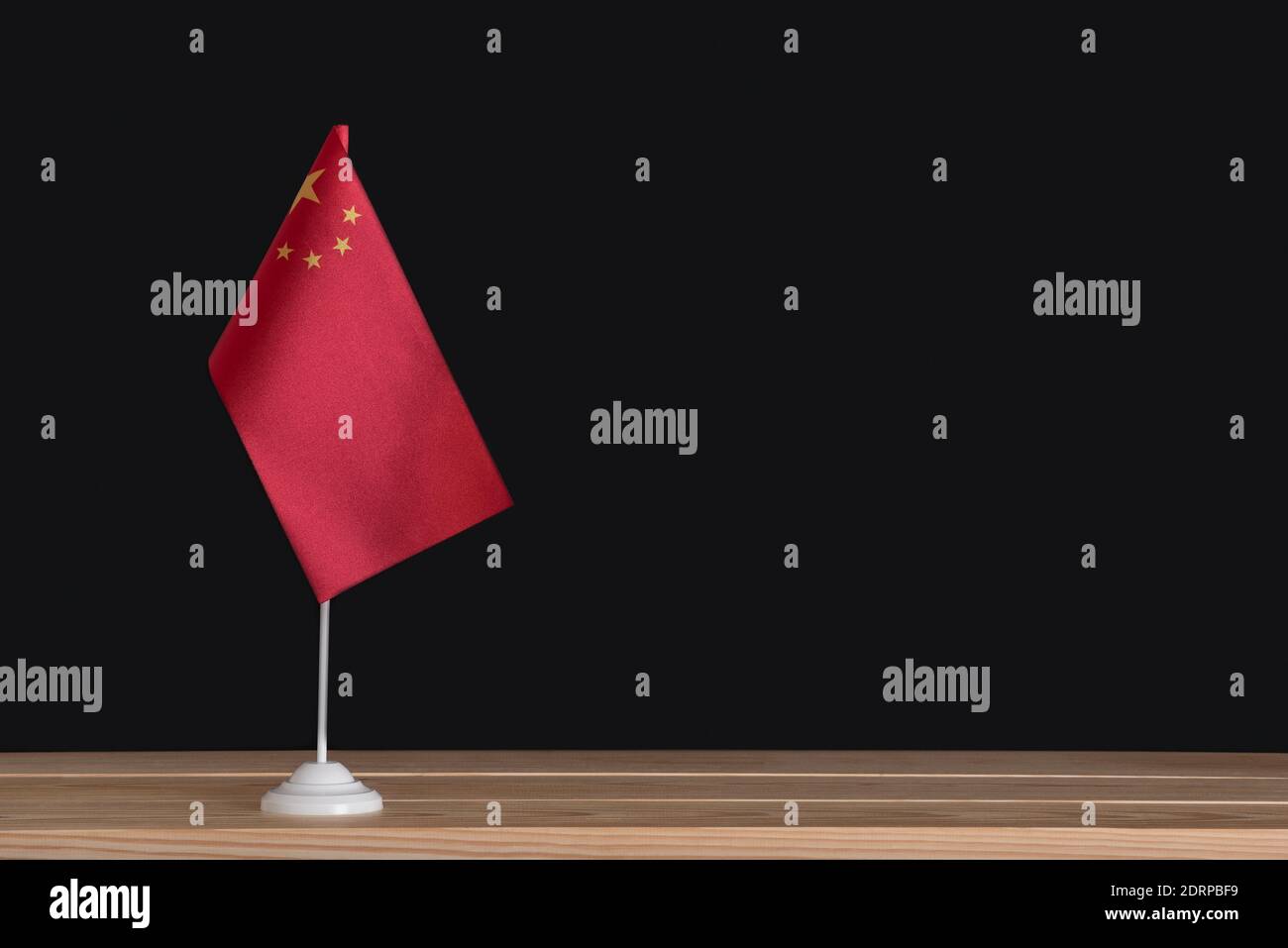 National table flag of China on black background. Red flag with stars ...