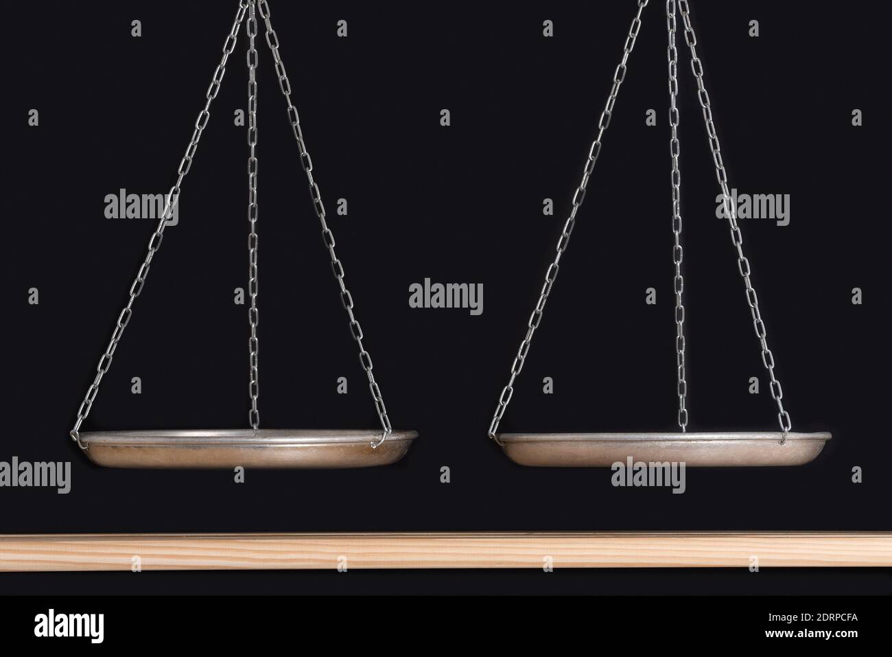 Scales are in balance. Black background and wooden shelf. Balance ...