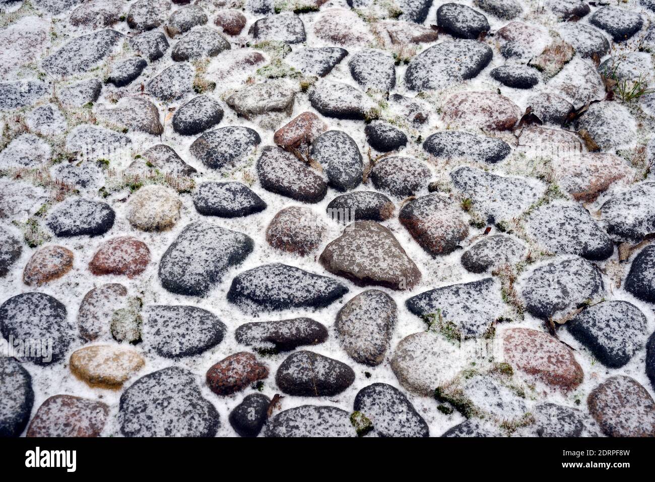 antique cobblestone pavement covered with first snow Stock Photo - Alamy