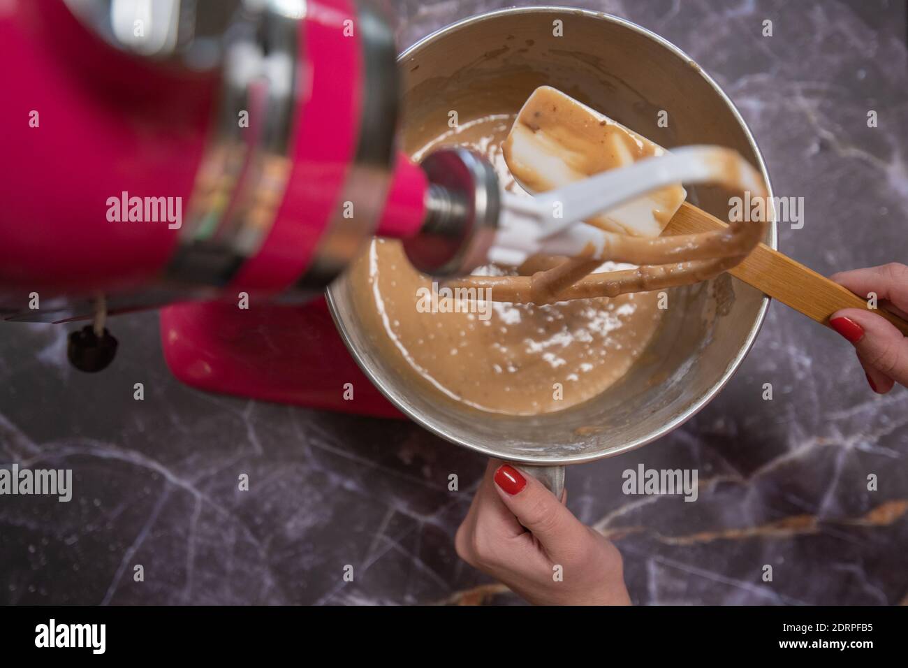 woman using a mixer to make desserts Stock Photo - Alamy