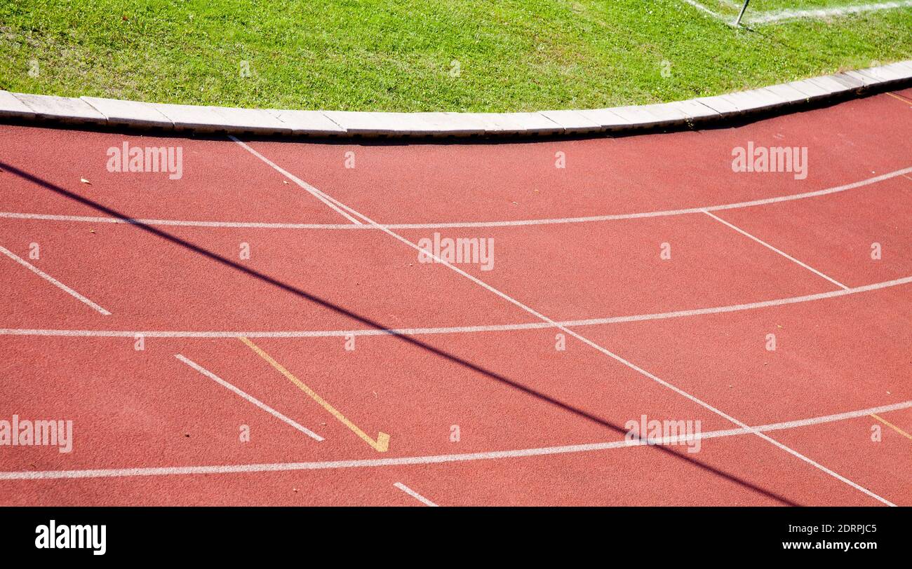 Running track with green grass Stock Photo - Alamy