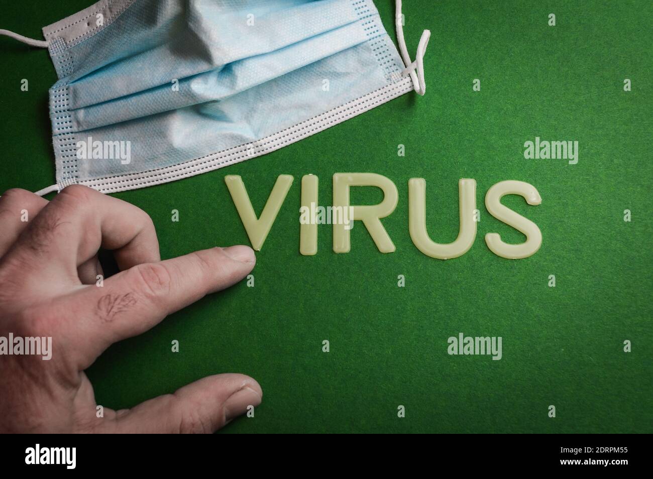 Human hand pointing the word Virus written with plastic letters on ...