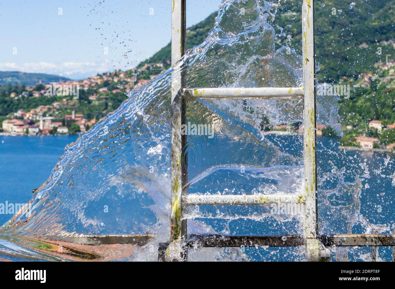 A closeup shot of water splashing over a metal ladder Stock Photo - Alamy