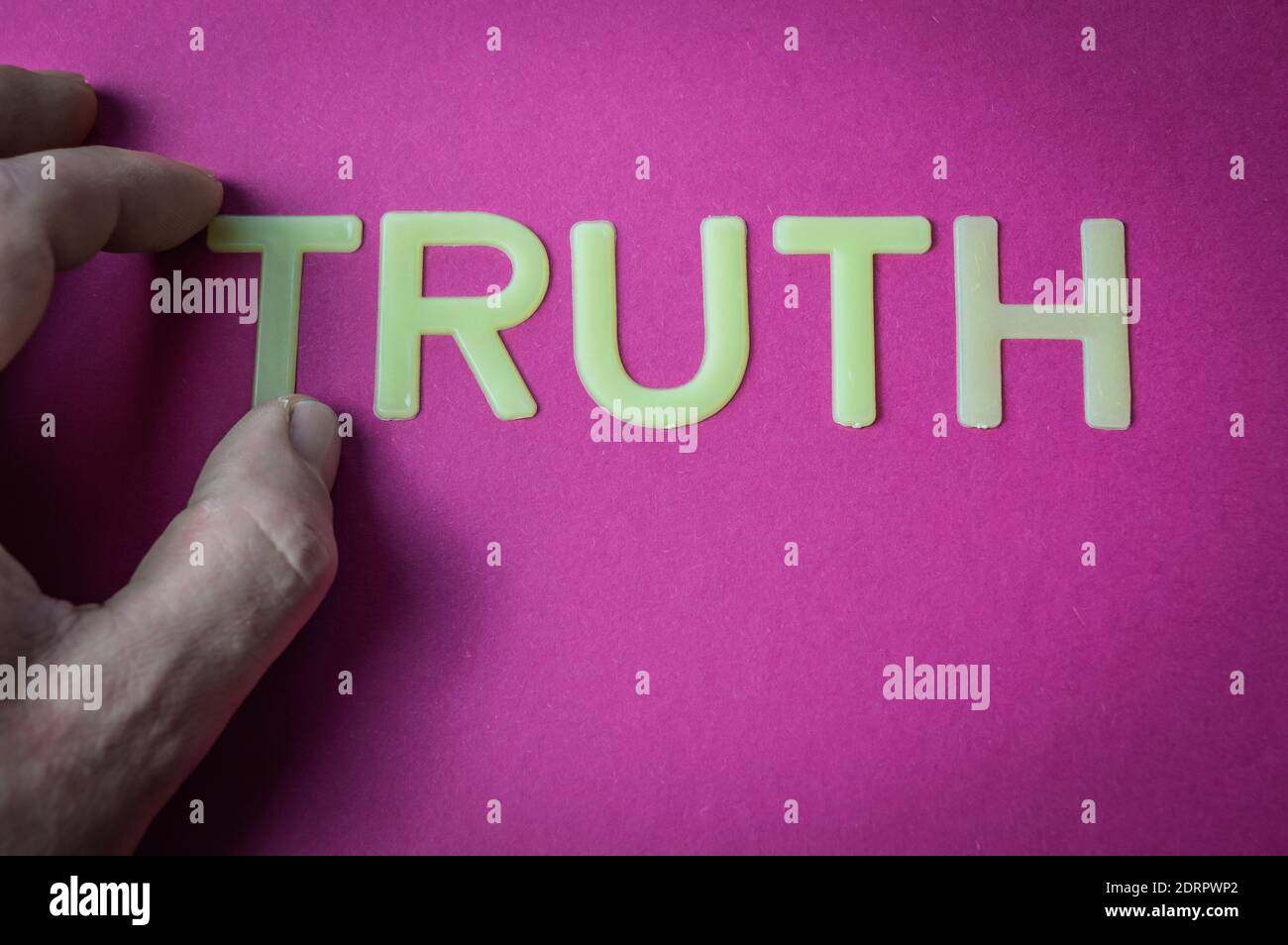 Human hand holding the word Truth written with plastic letters on a ...