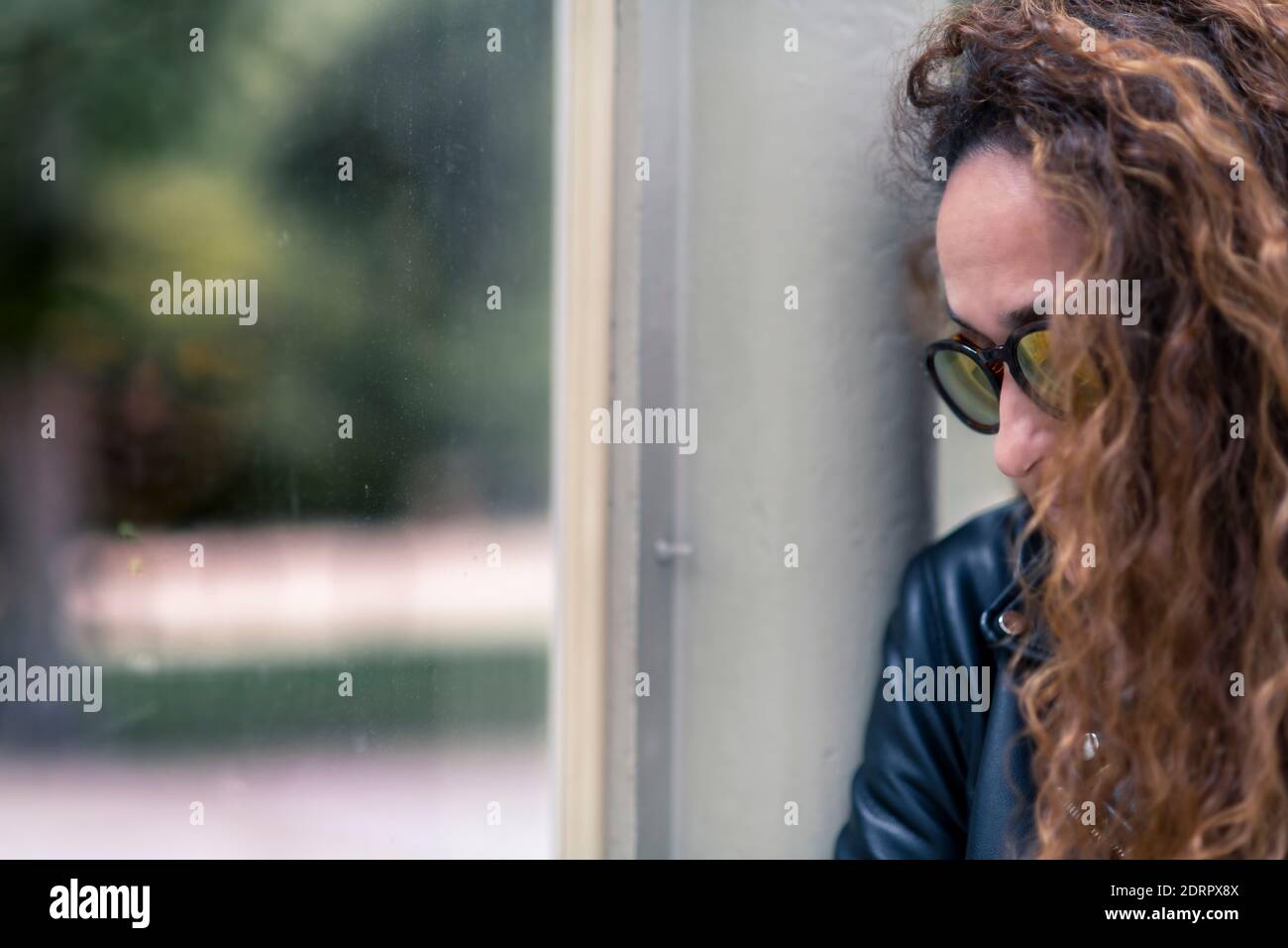 Attractive woman looking through the glass, relaxing Stock Photo - Alamy