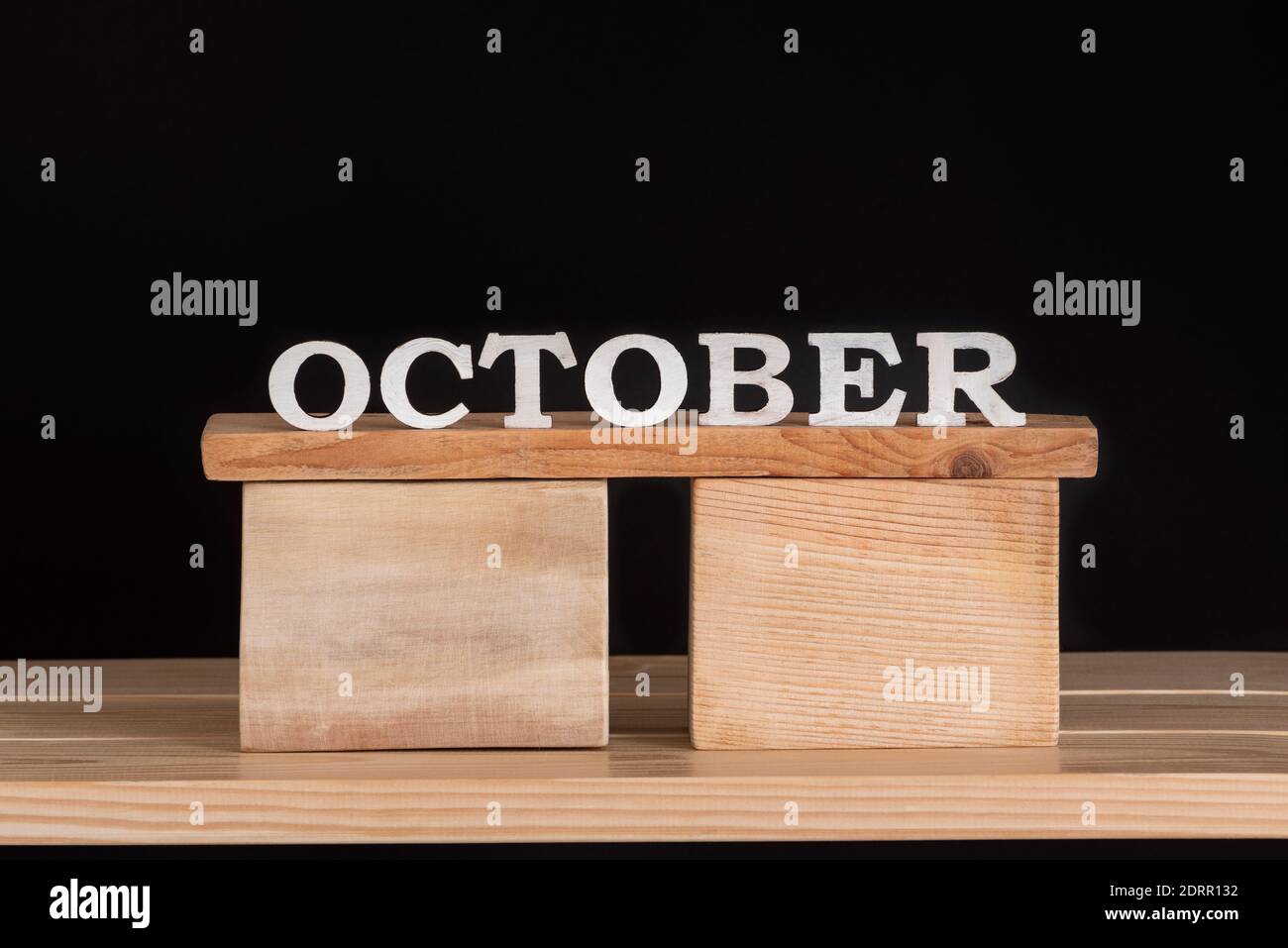 Word October by wooden letters on black background. Front view. Autumn ...