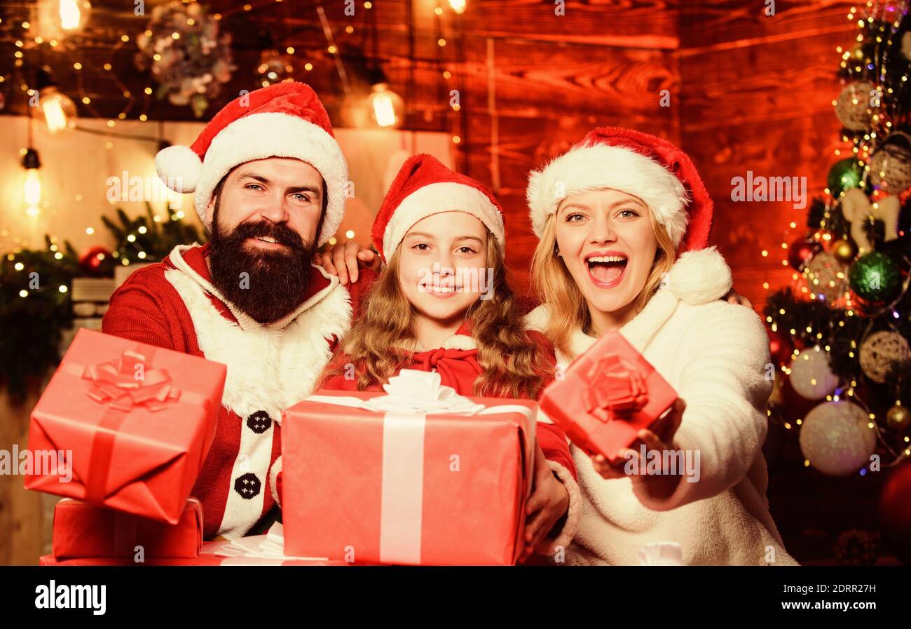 Lovely daughter with parents wearing Santa hat. Gifts from Santa ...