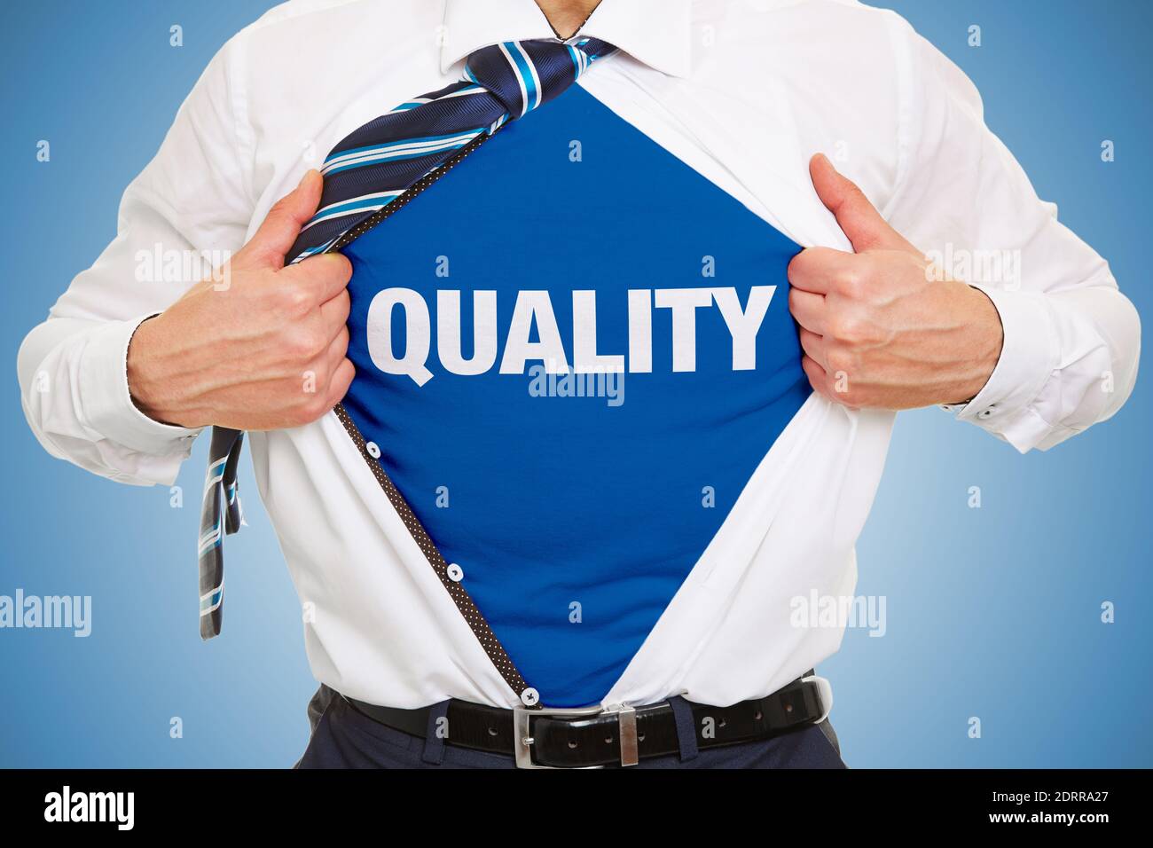 Business man opens shirt and wears lettering Quality underneath as a ...
