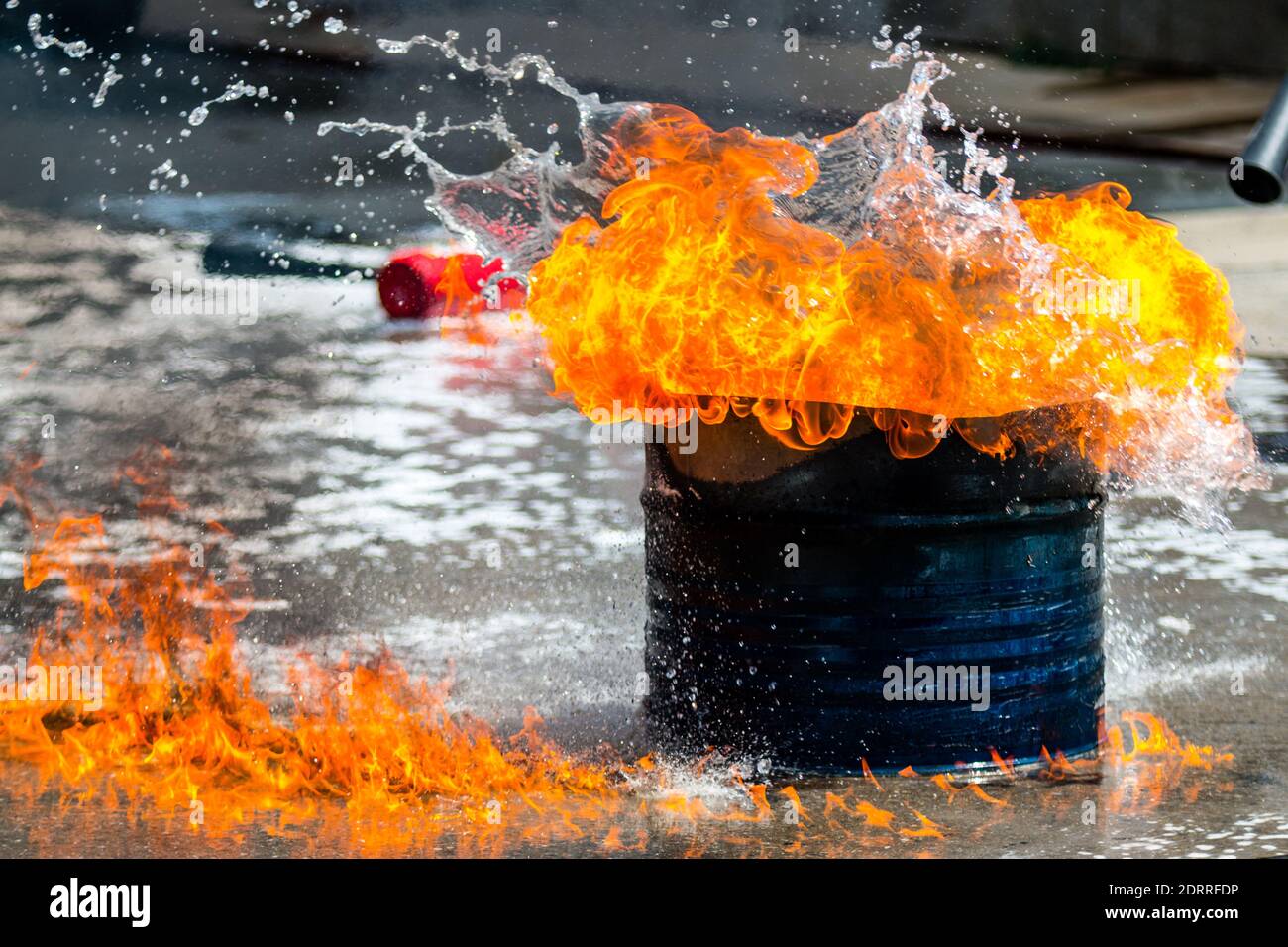 Water Splashing On Fire In Container Stock Photo - Alamy