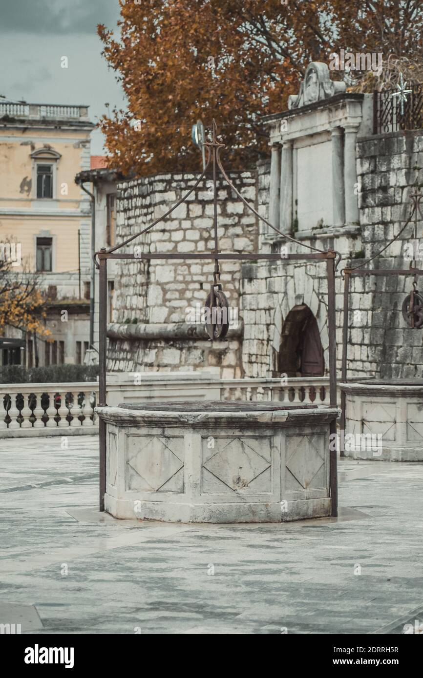A vertical shot of the historic water well in the five well square in ...