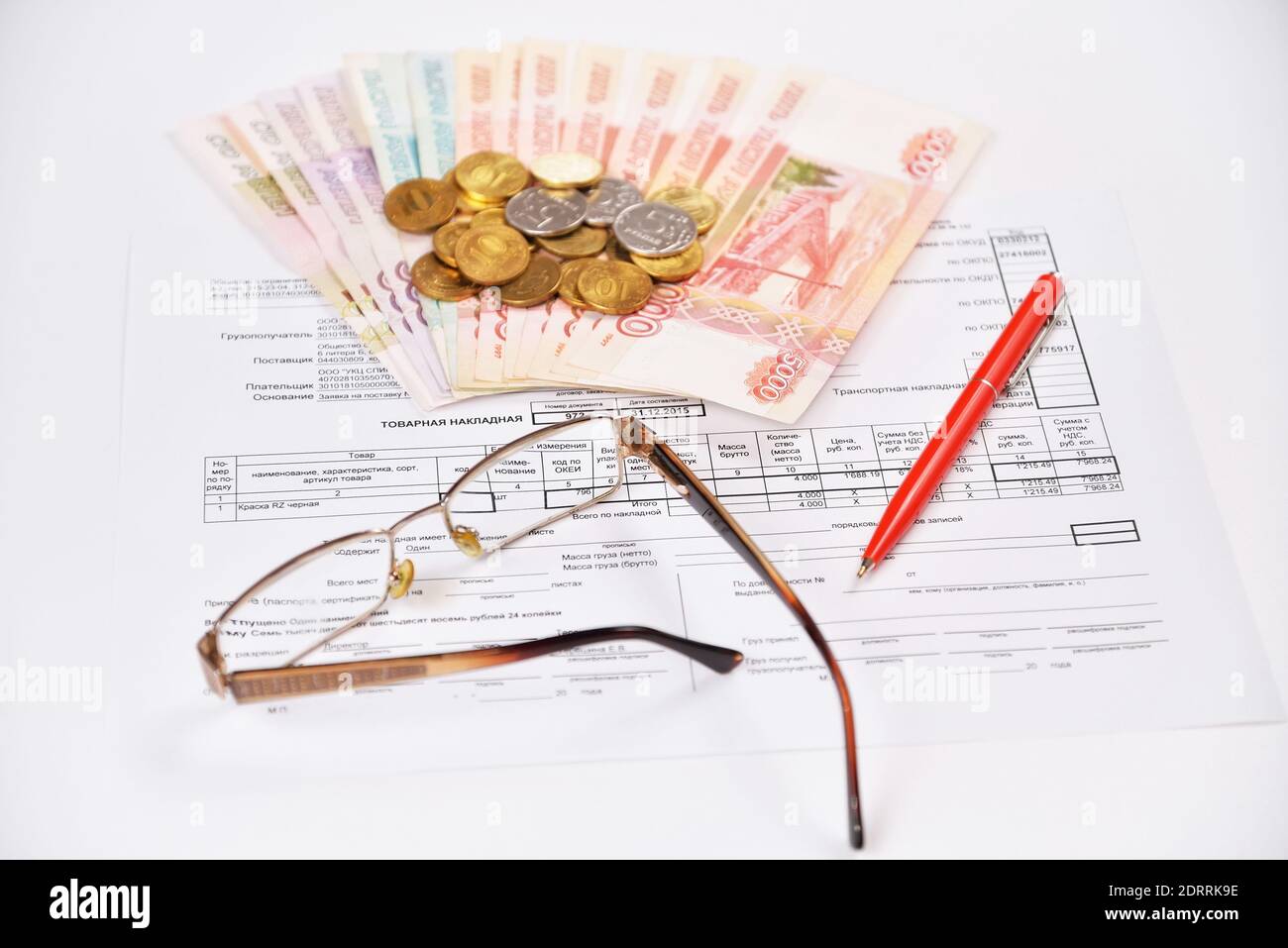 Desk accountant: waybill, paper money, coins, glasses and fountain pen ...