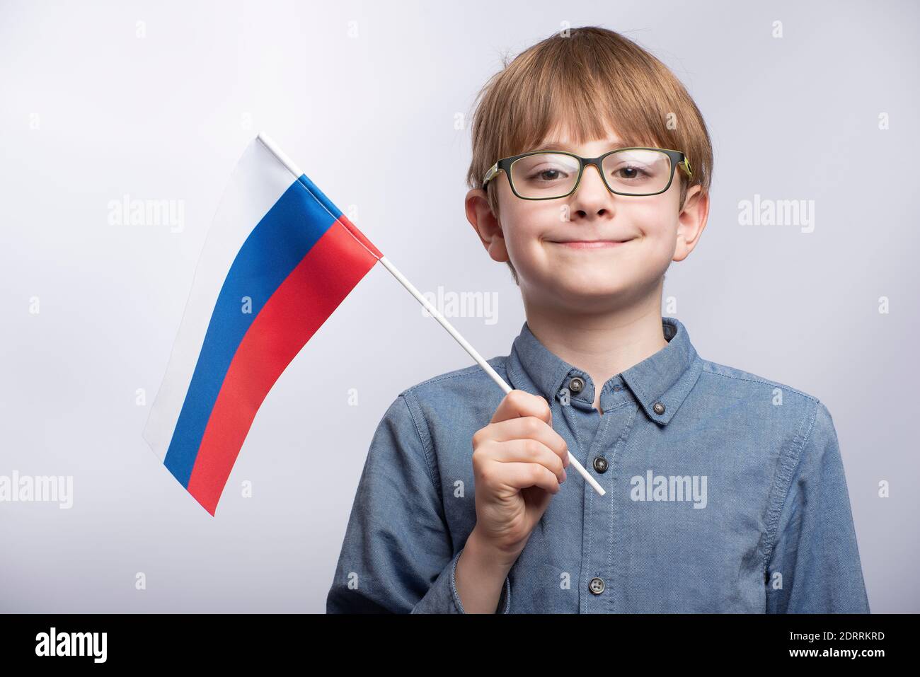 Boy holding flag of Russia. Portrait of teenager with glasses with flag ...