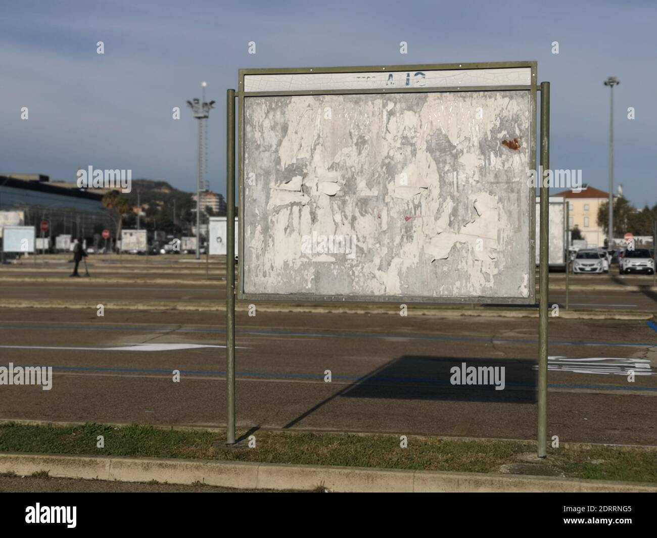 An old blank advertising sign with torn posters on an urban street ...