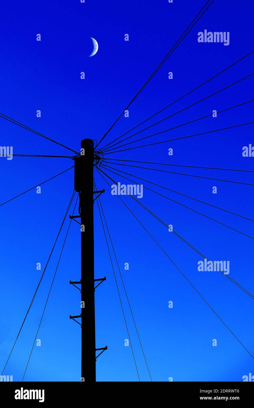 Comms telegraph telephone pole and radiating wires at evening with ...