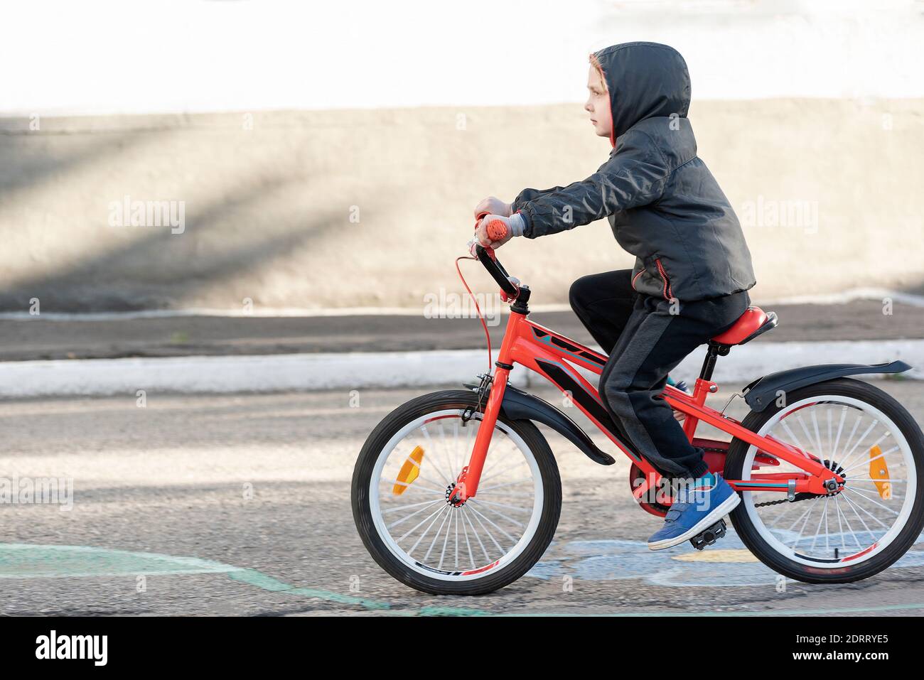 Teenager riding Bicycle. Boy learning to ride bike. Side view Stock ...