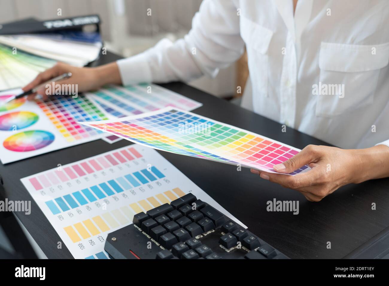 creative graphic designer choosing color scale for editing artwork ...