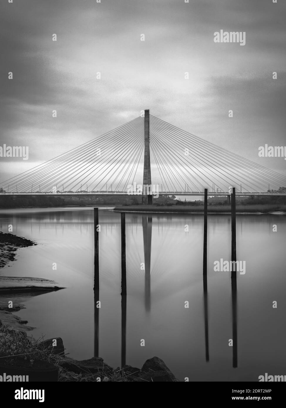 A vertical grayscale shot of the River Suir Bridge with a dramatic ...
