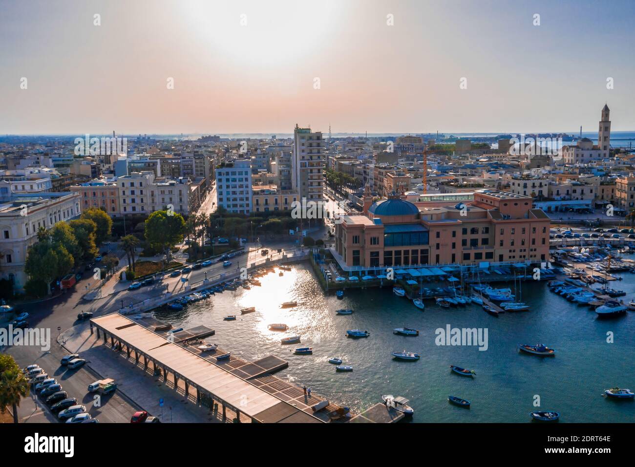 An aerial shot of a beautiful city with a port and boats floating on ...
