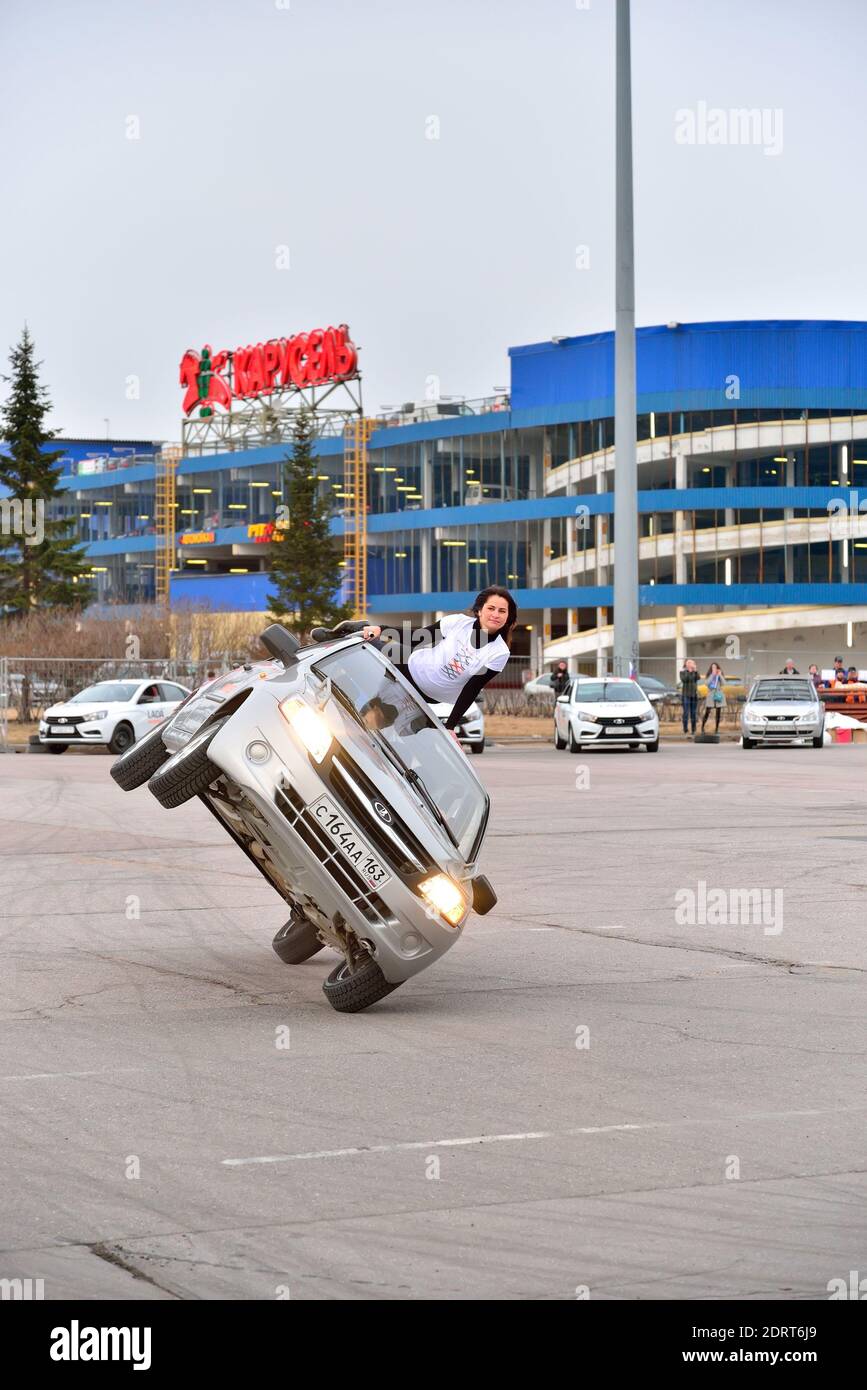 ST.PETERSBURG, RUSSIA - APRIL 07, 2017: Girl stunt rider leaned to the ...