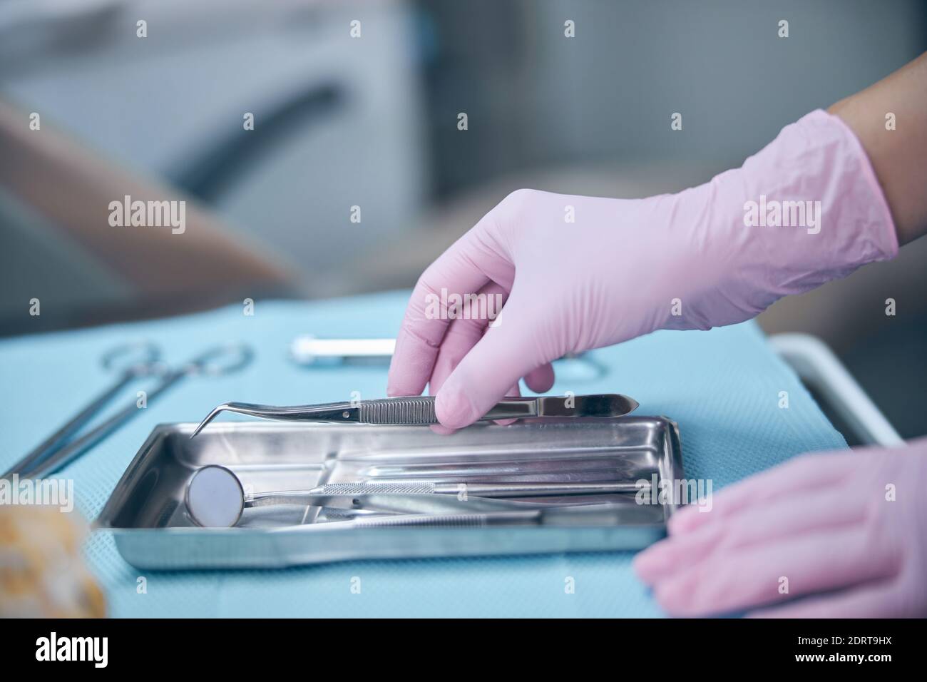 Female dentist using sterile instruments during treatment Stock Photo ...