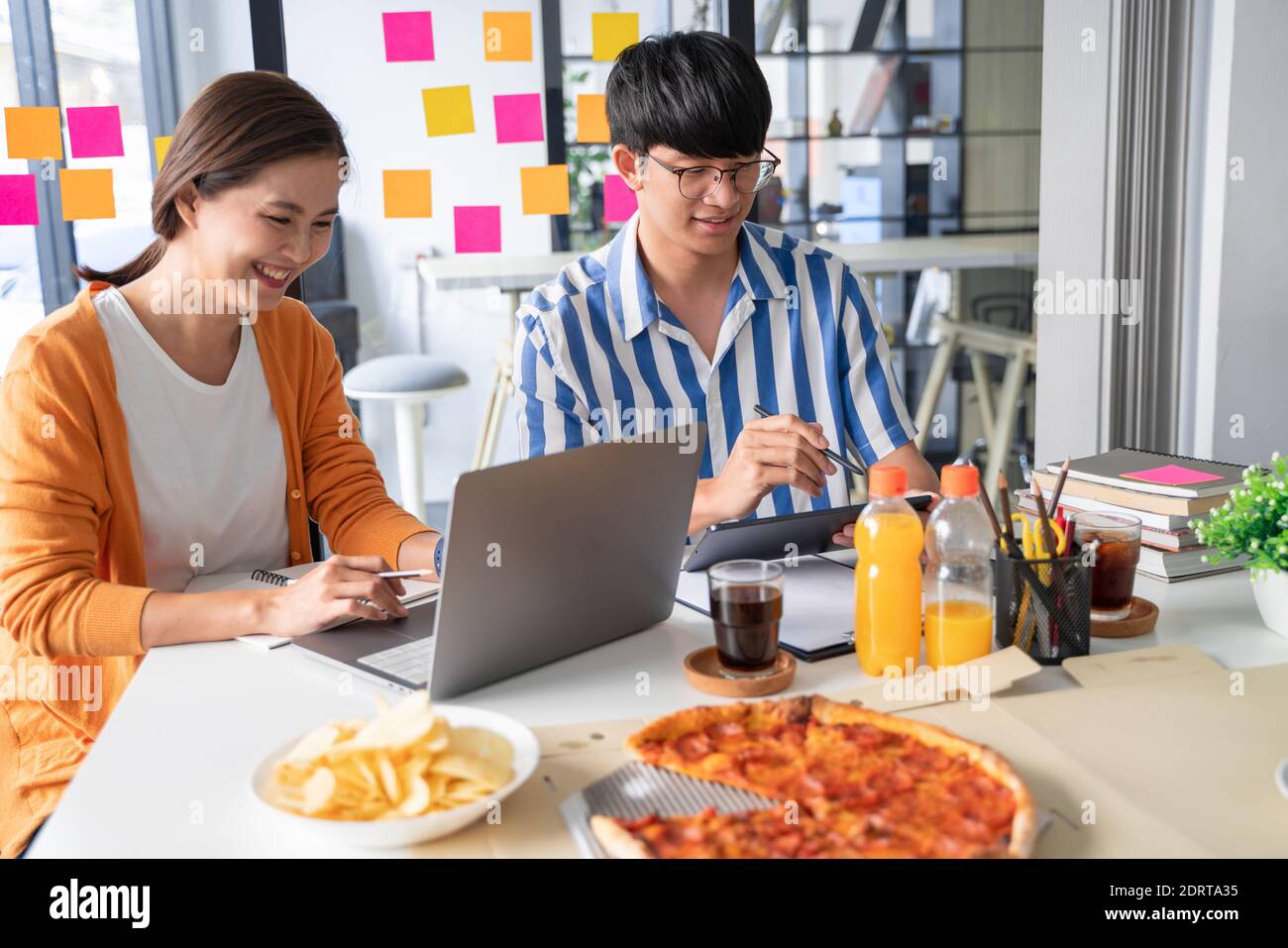 Business team workers discussing work and prepare pizza and potato ...