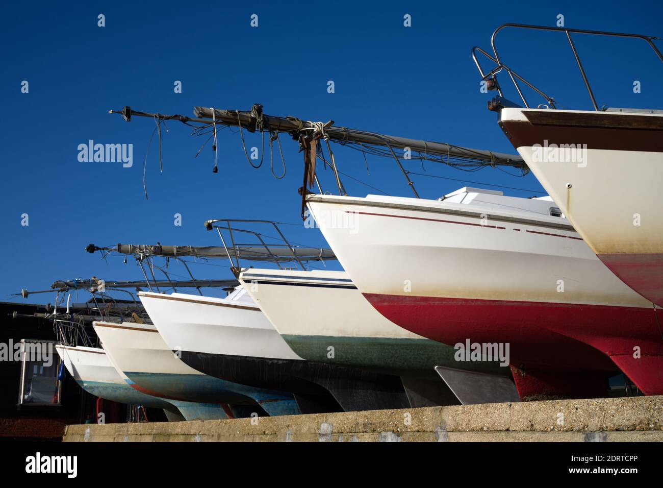 Yachts at Dell Quay dry docked with the bow of the yachts in a row ...