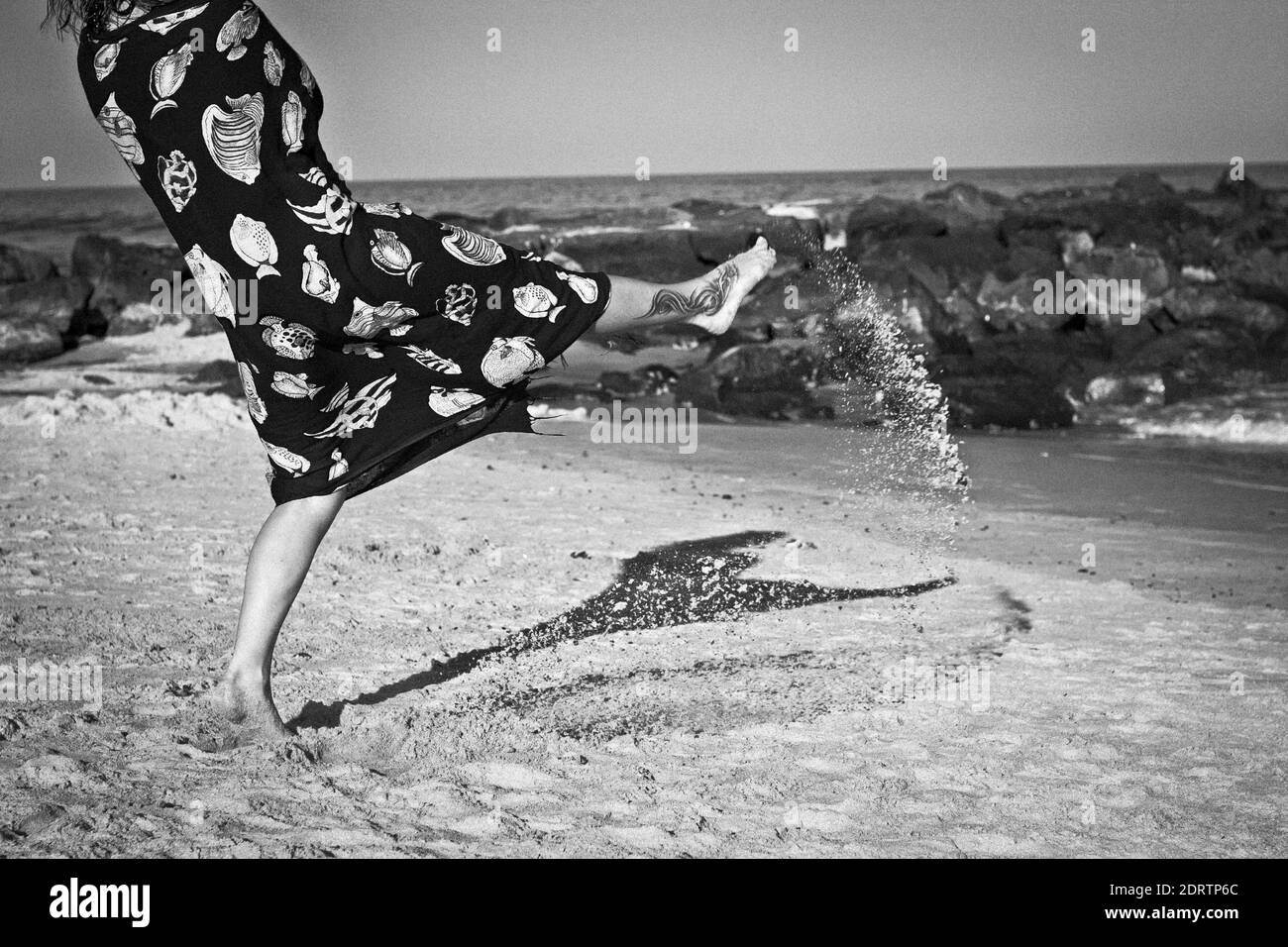 Woman kicking the sand Black and White Stock Photos & Images - Alamy