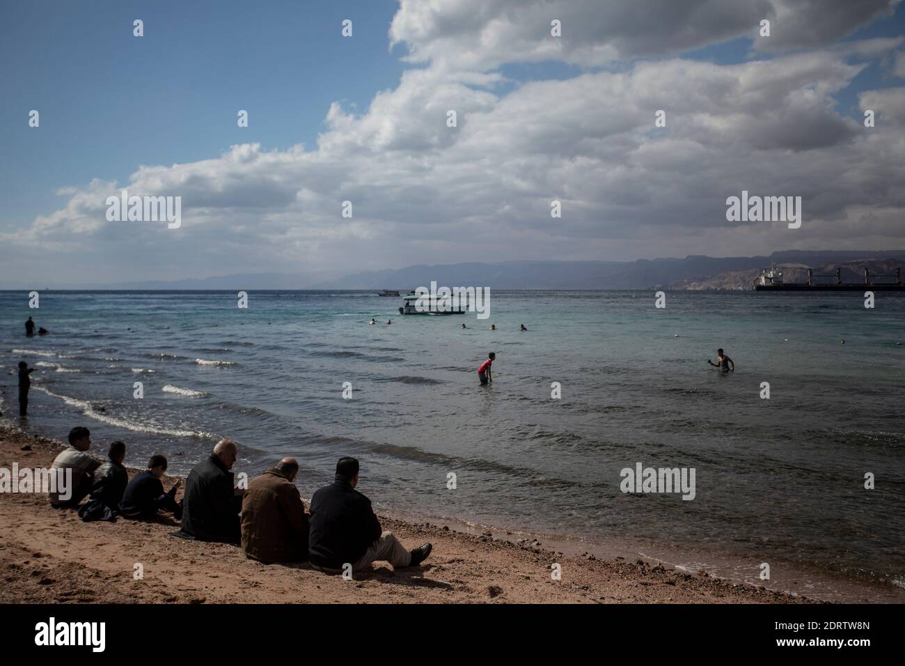 Local people along the beach in Aqaba, Jordan. On the other side Israel ...