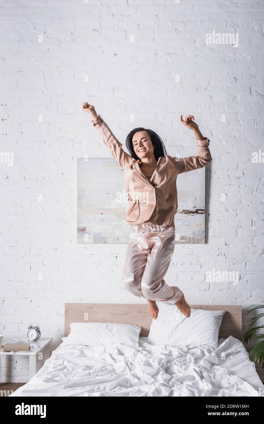 Woman happy jumping bed hi-res stock photography and images - Alamy