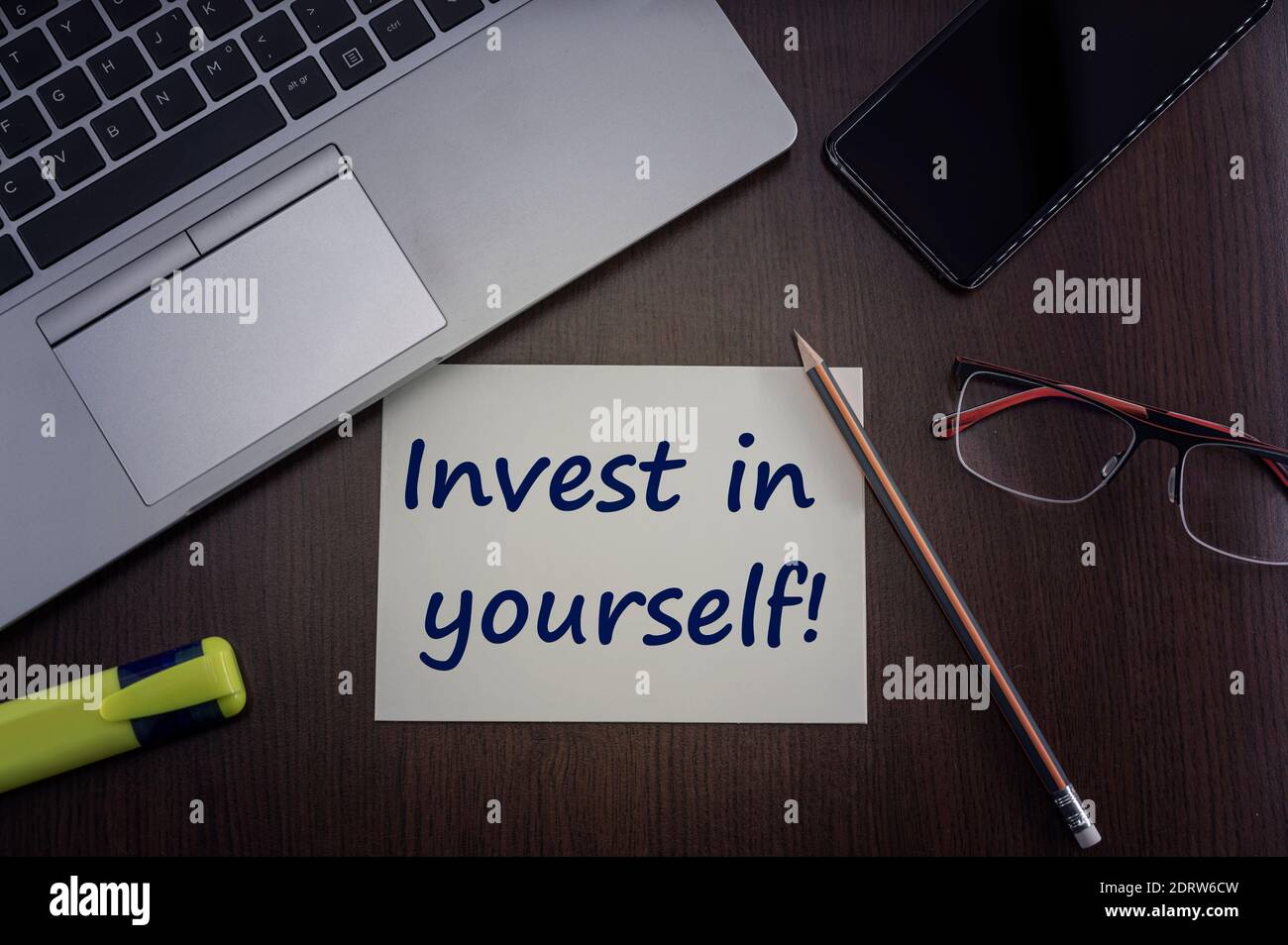 Invest in yourself card. Top view of office table desktop background ...