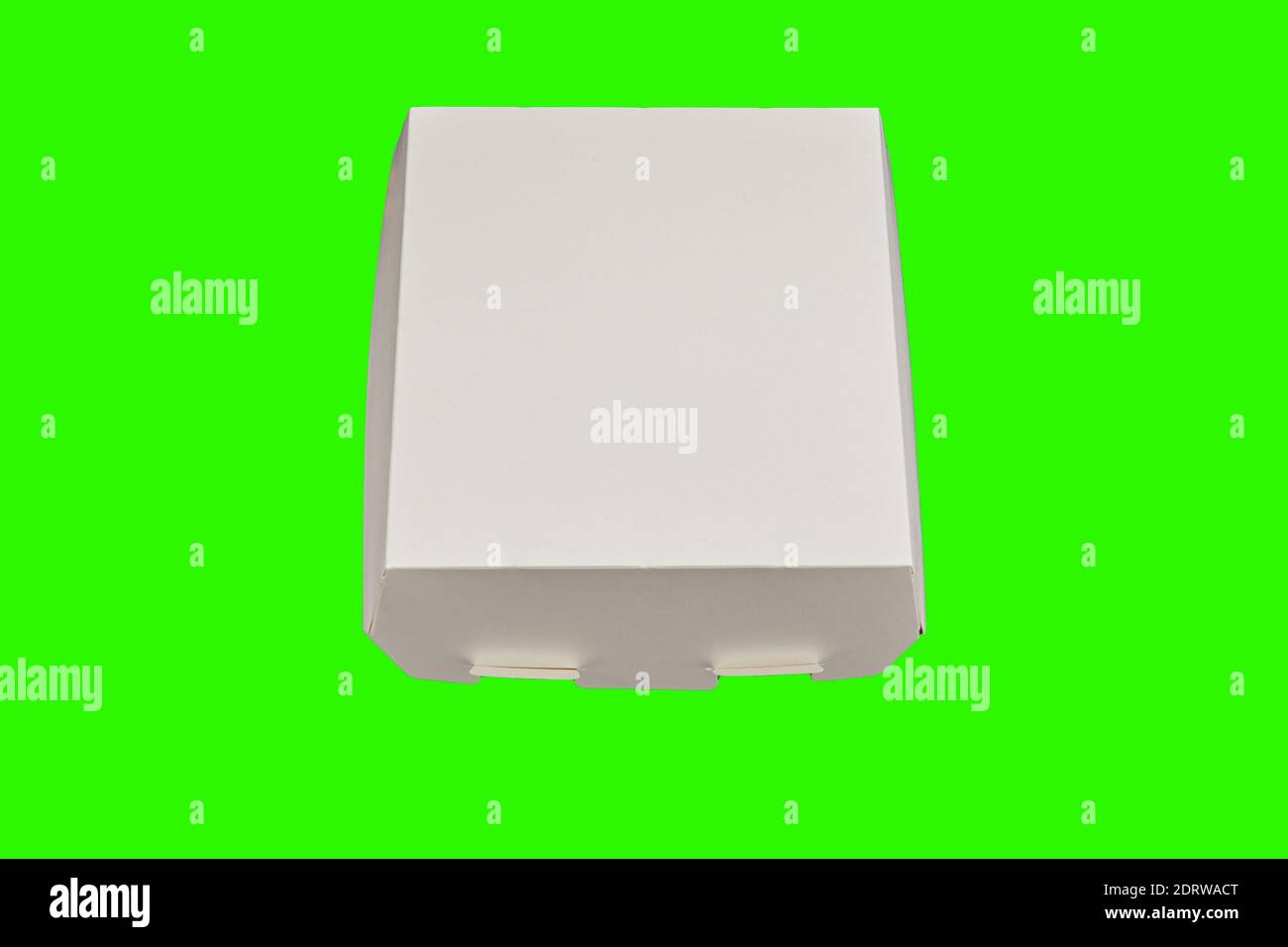 White disposable cardboard box for food delivery on green background ...