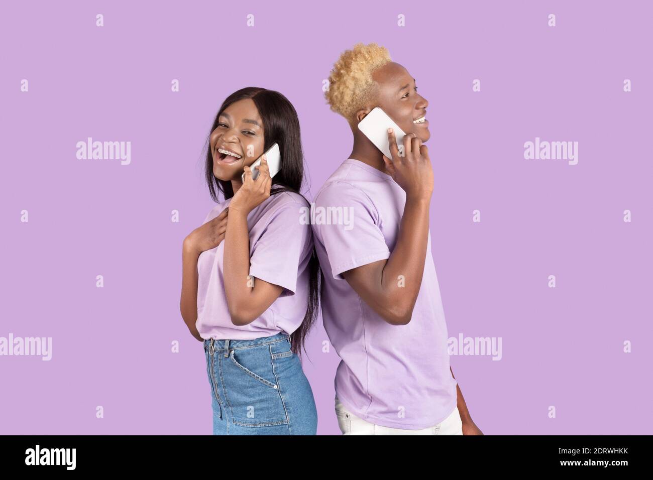 Positive black man and his girlfriend calling on smartphones, having ...