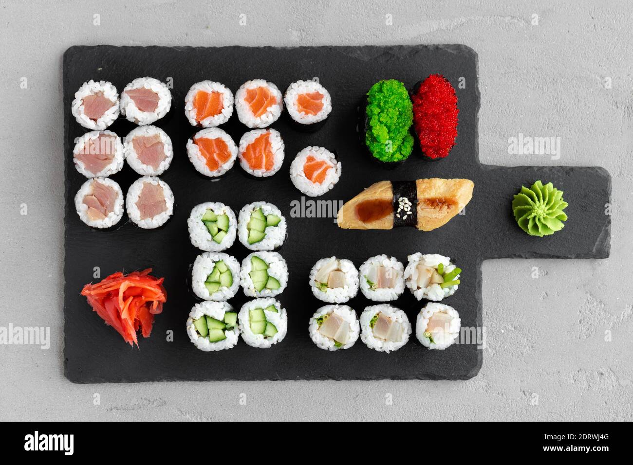 Maki sushi set served on black stone tray Stock Photo - Alamy