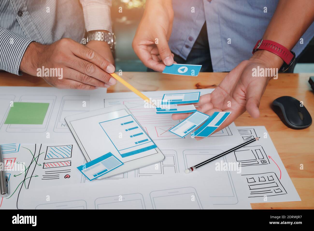 UX or UI designers designing on their smartphone application layout ...