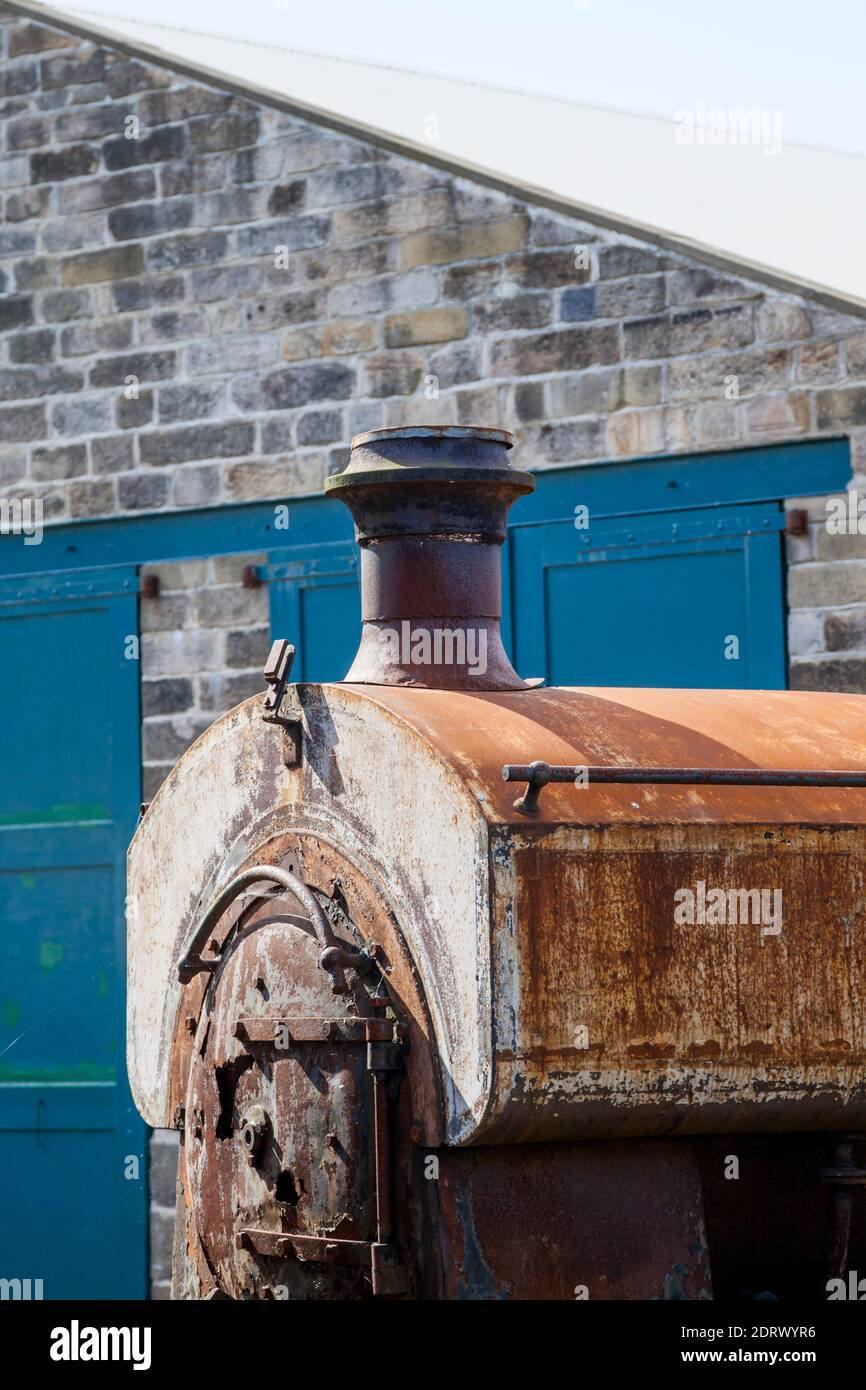An old rusty 0-6-0 steam locomotive in front of the engine shed at ...