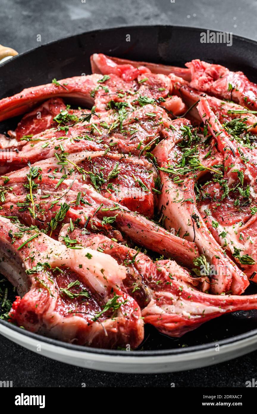 Rack of lamb marinated with thyme and mint , raw meat with bone ...