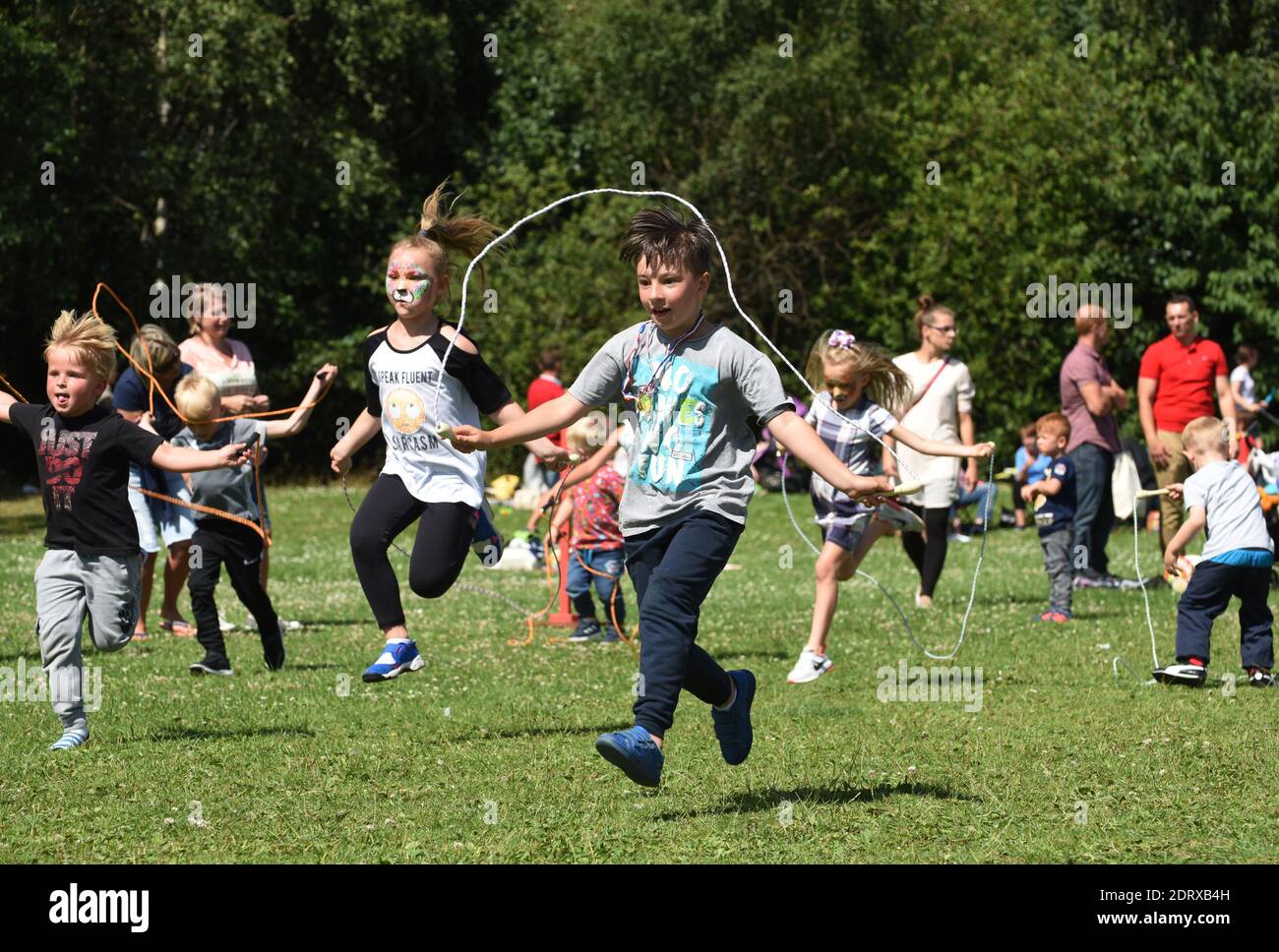 Children playing the skipping race in the park in Nechells, Birmingham ...